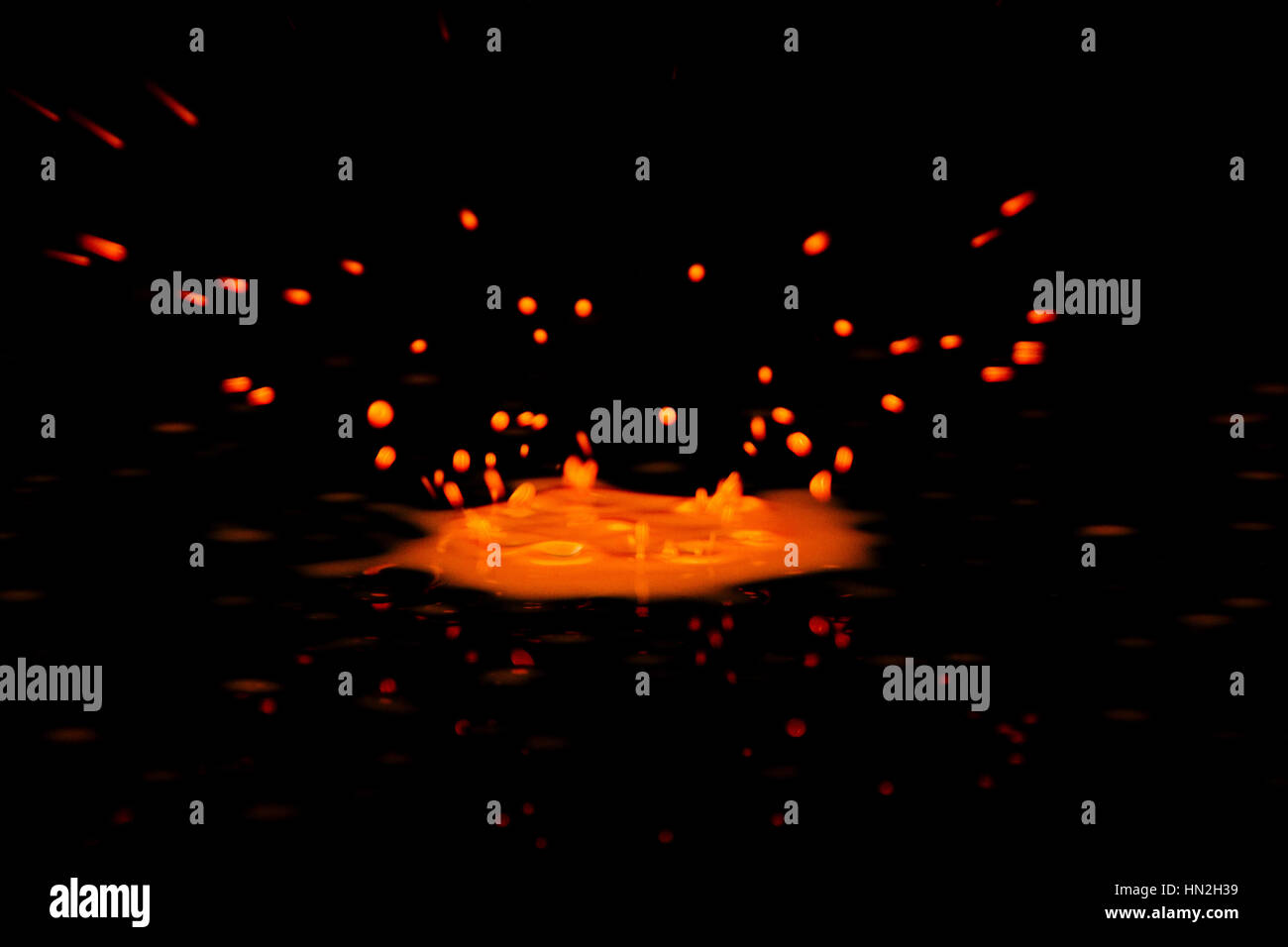 Colorful paint drop splashing on black a background Stock Photo - Alamy