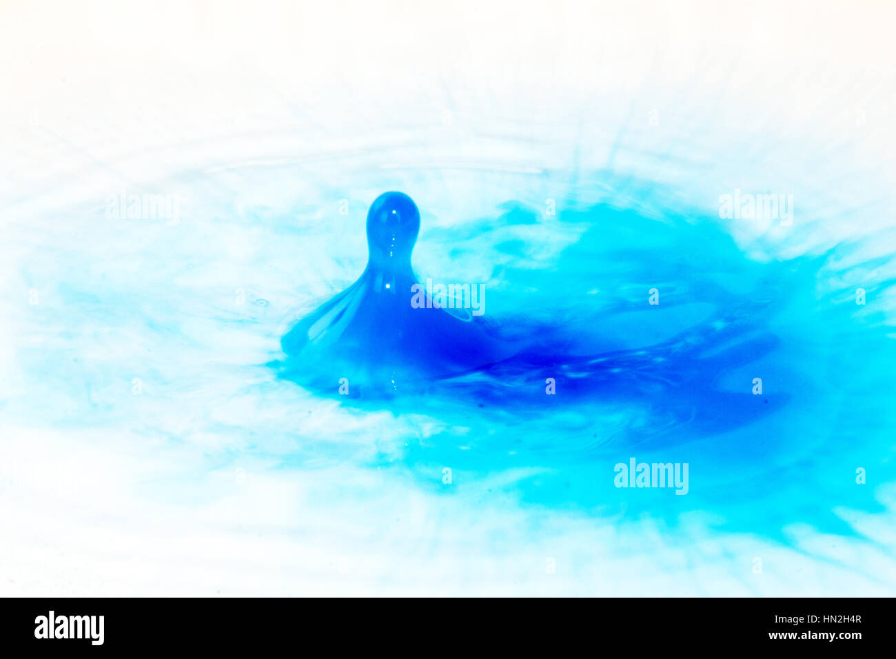 Colorful paint drop splashing on black a background Stock Photo - Alamy