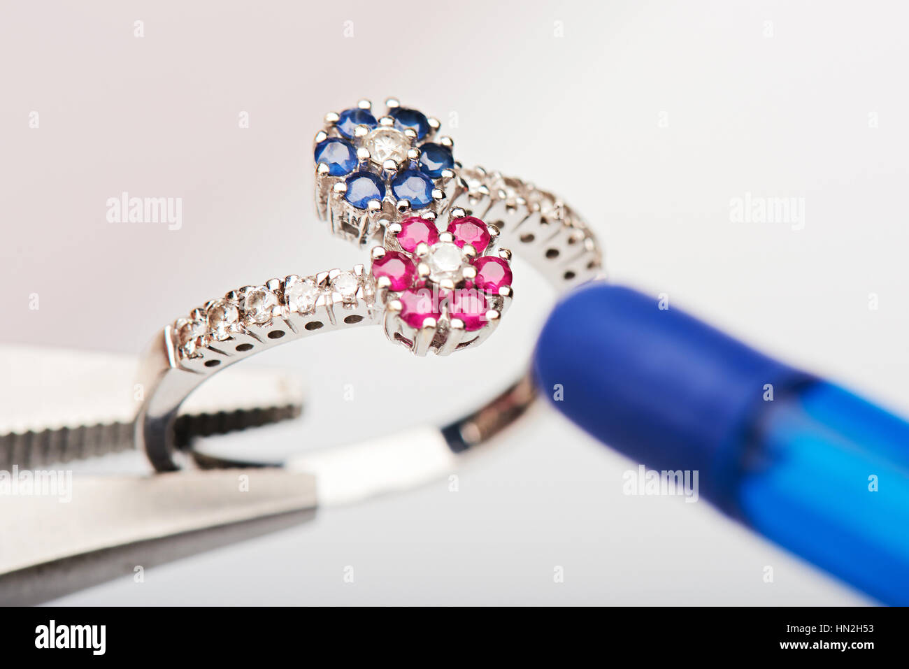 close up maintenance of gold ring isolated on white Stock Photo - Alamy