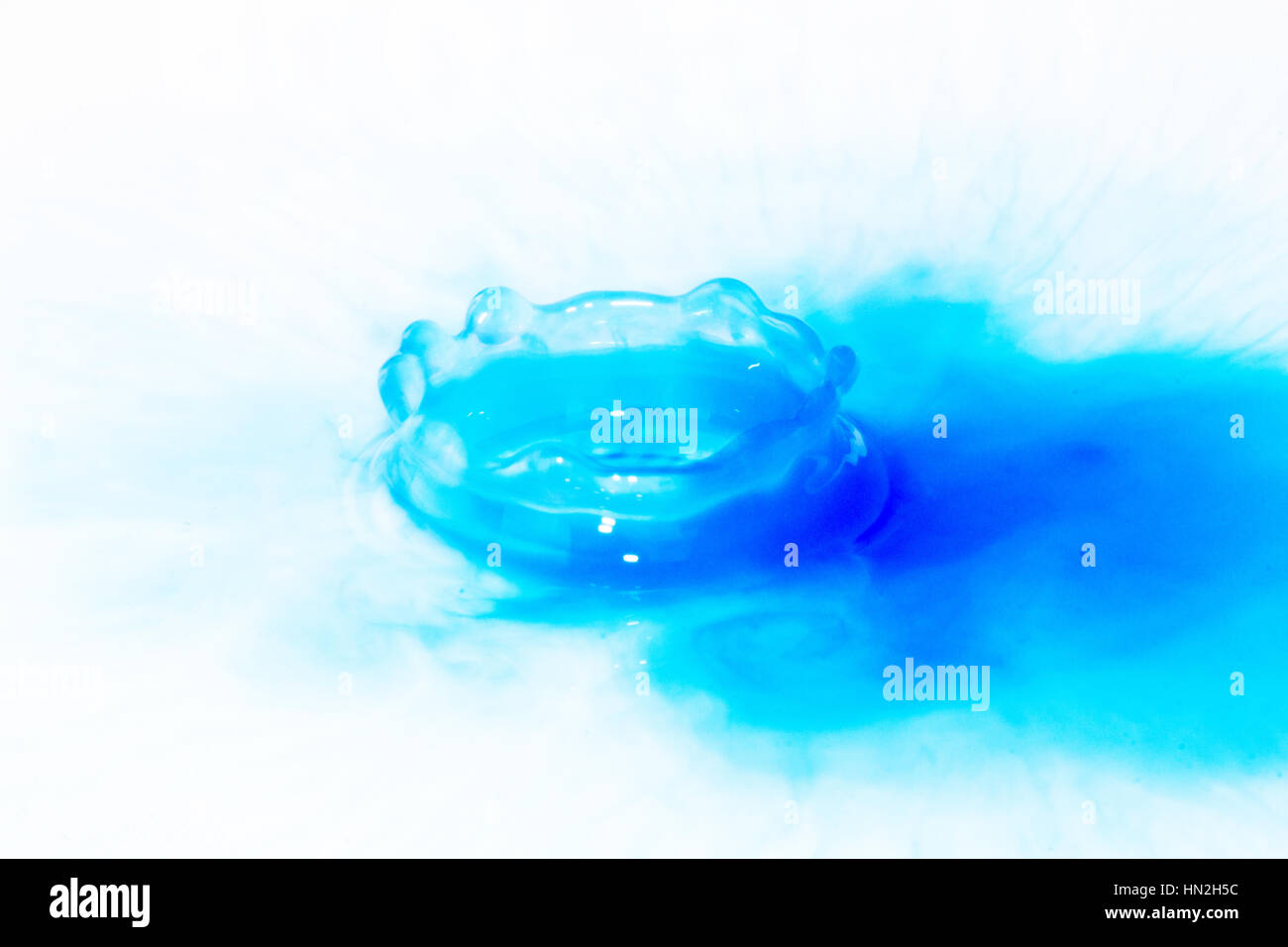 Colorful paint drop splashing on black a background Stock Photo - Alamy