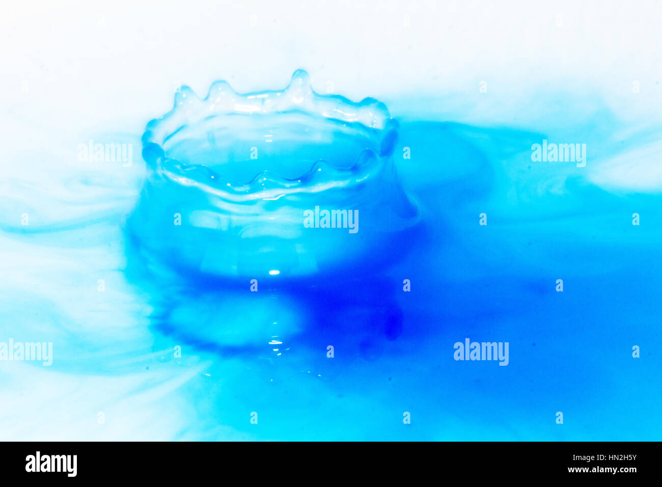 Colorful paint drop splashing on black a background Stock Photo - Alamy