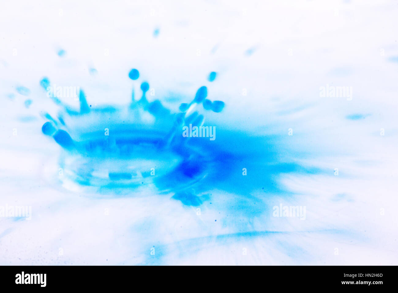 Colorful paint drop splashing on black a background Stock Photo - Alamy