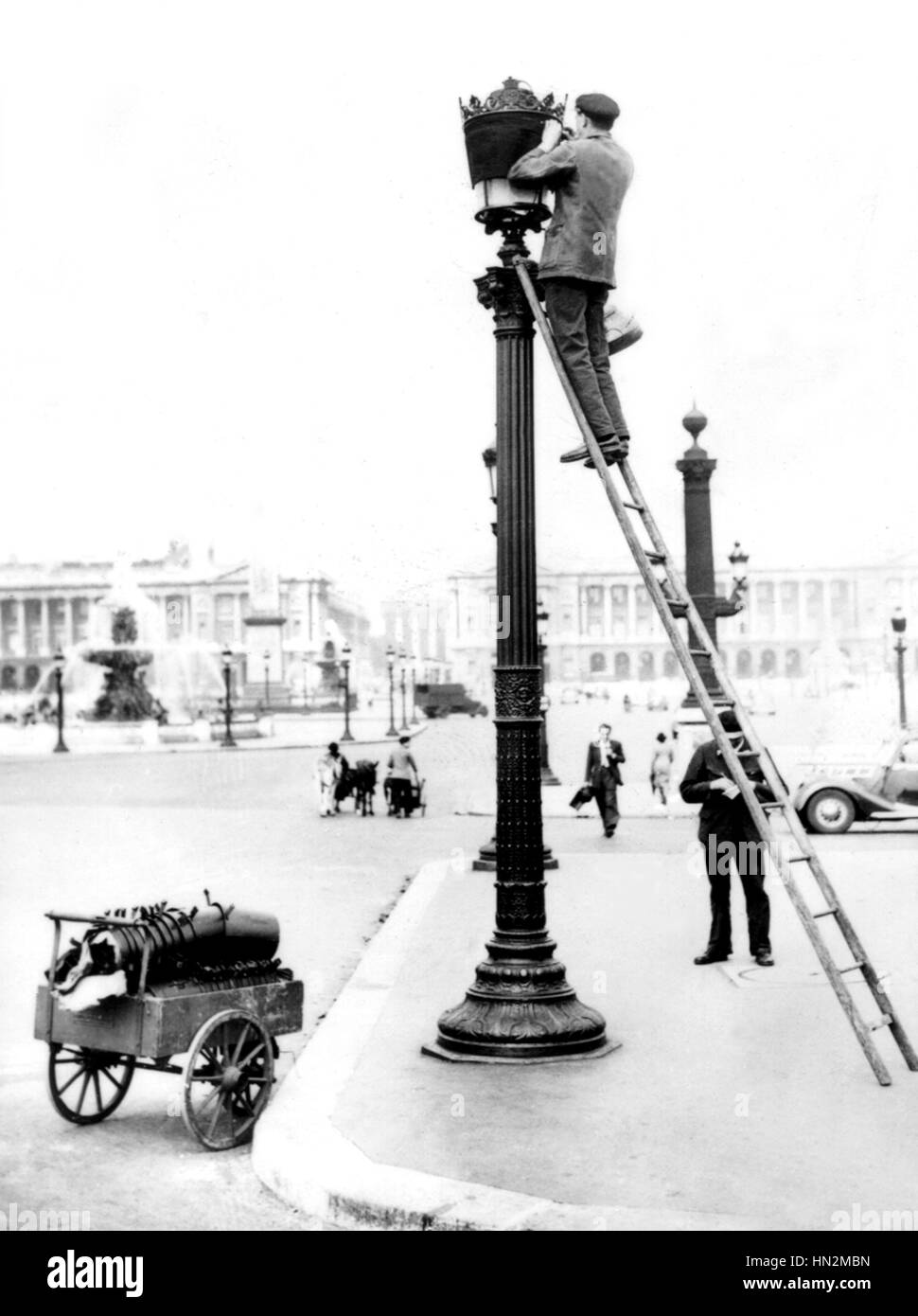 Paris. Installation of security blue lamps on public street lamps. 1939 ...