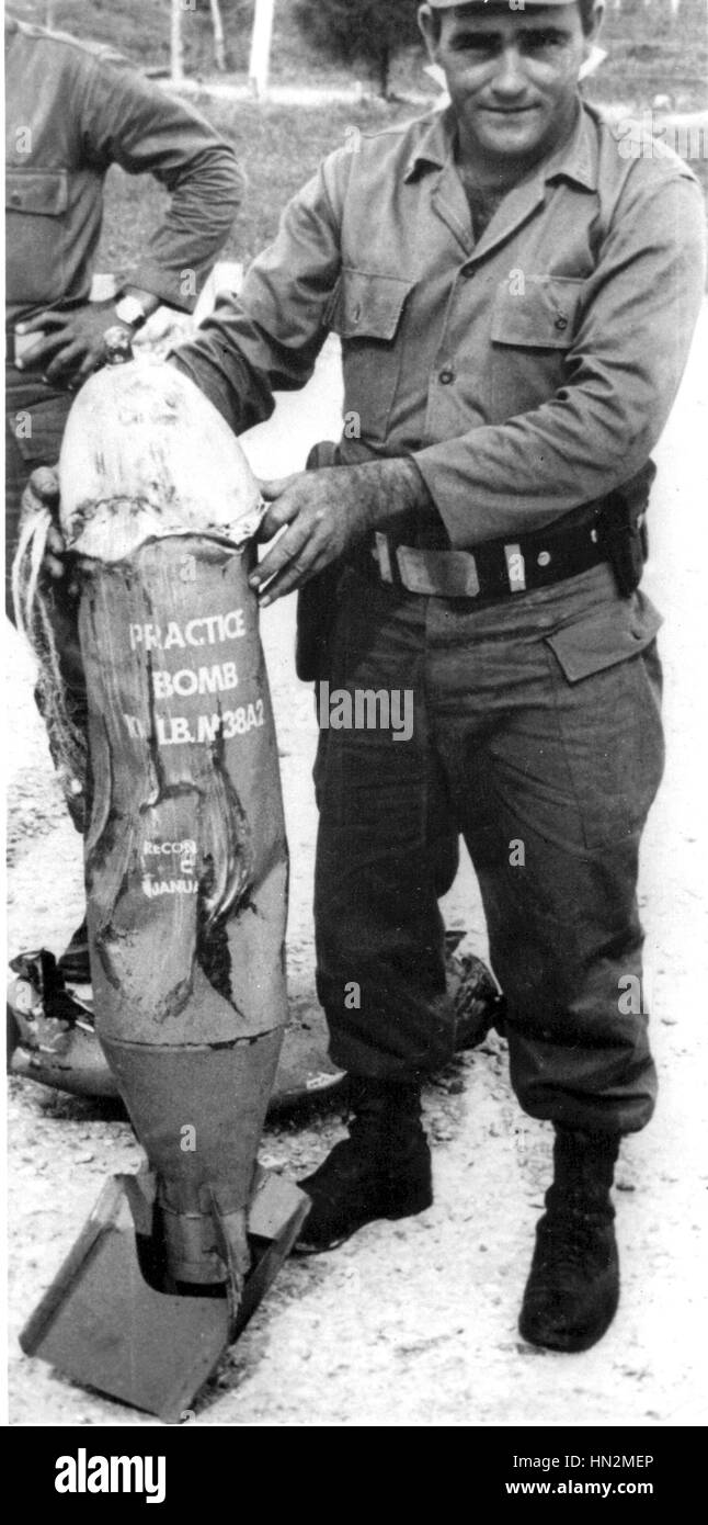 Landing at the bay of Pigs. Cuban soldier showing an American bomb ...