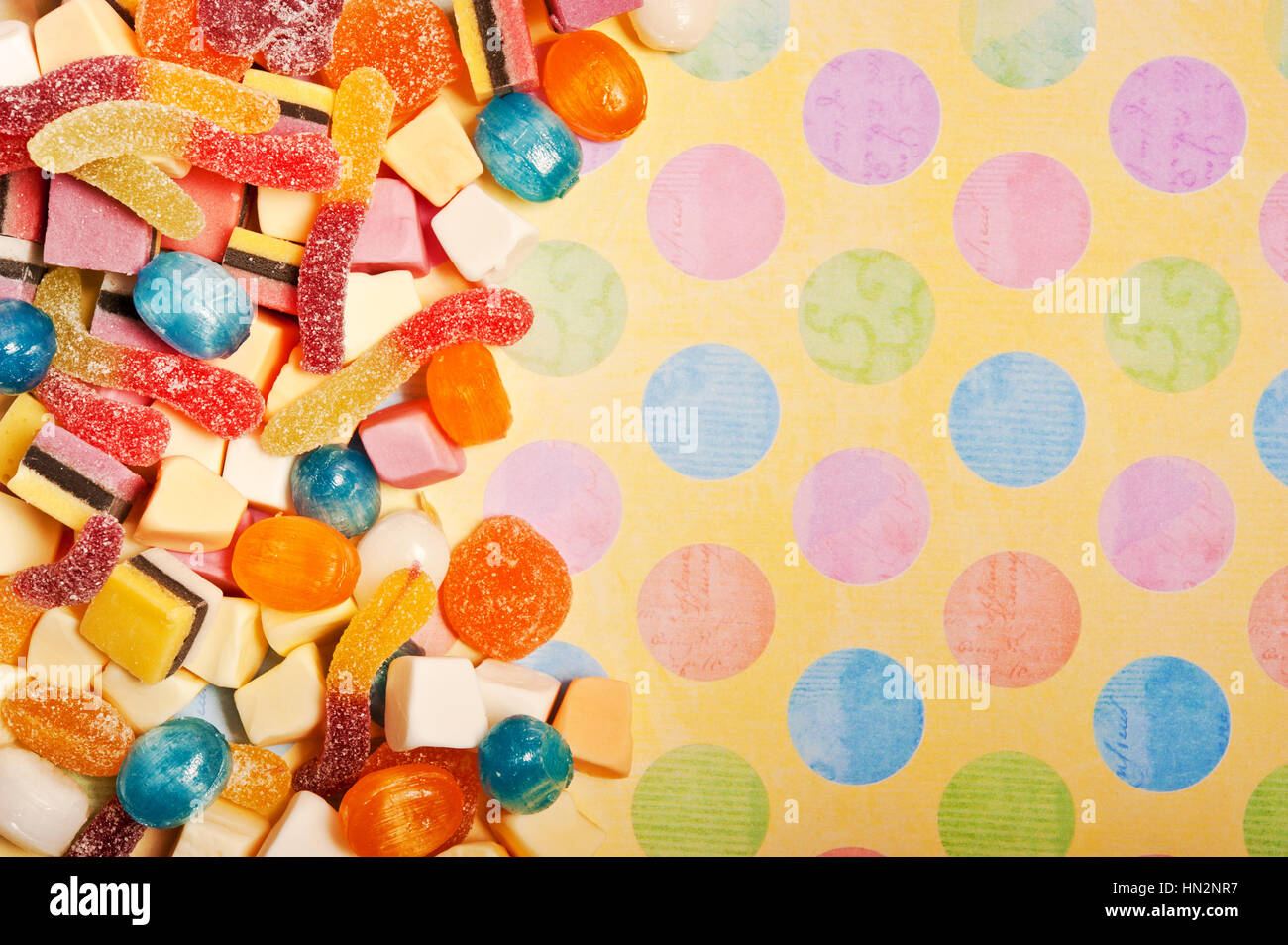 variety of candies scattered on a colorful background Stock Photo - Alamy
