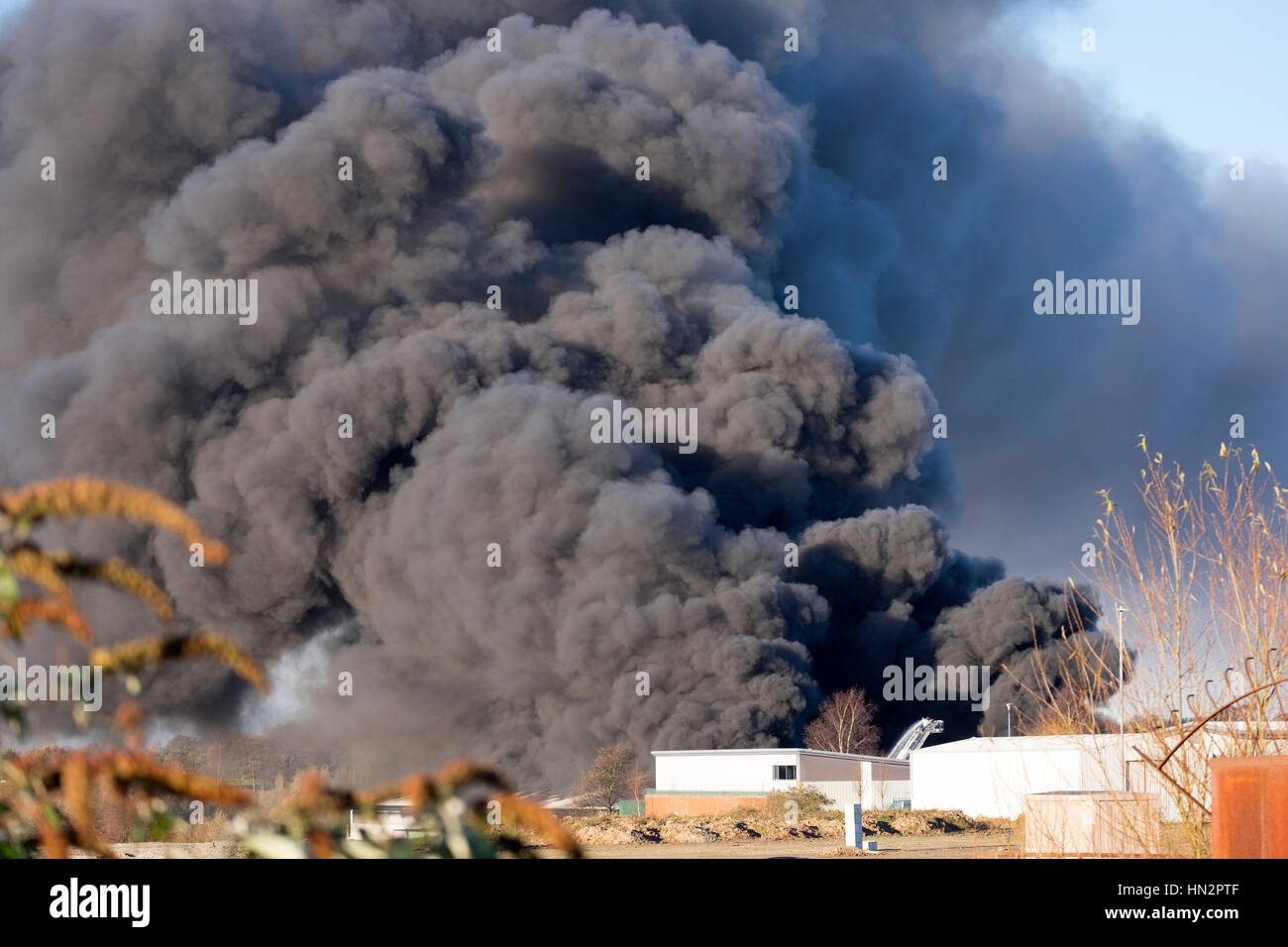 Large factory fire with plumes of thick black smoke Stock Photo - Alamy