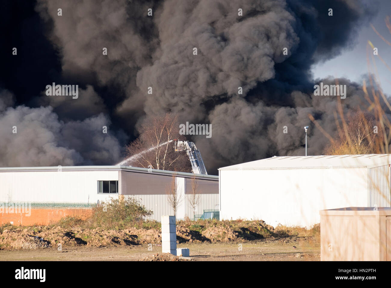 Large factory fire with plumes of thick black smoke Stock Photo - Alamy