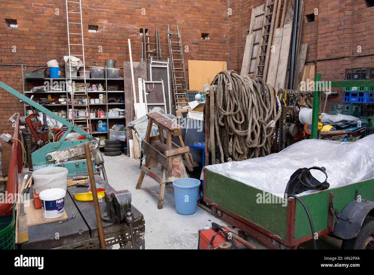 Old engineers workshop with bundles of rope and metalworking tools and ...