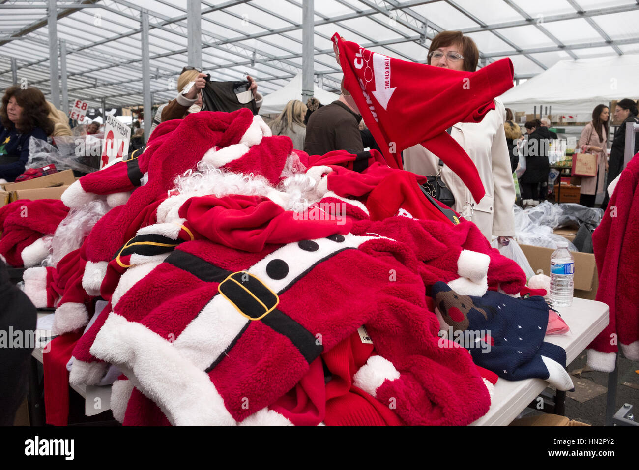 Lady at market selling Santa costumes Stock Photo - Alamy
