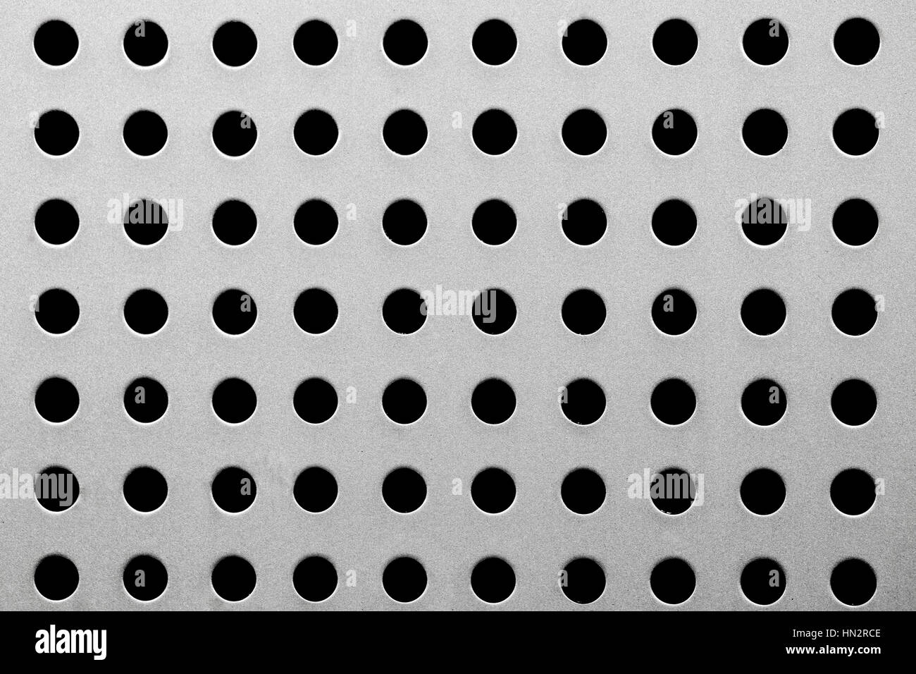 Metal texture with round holes close up Stock Photo - Alamy