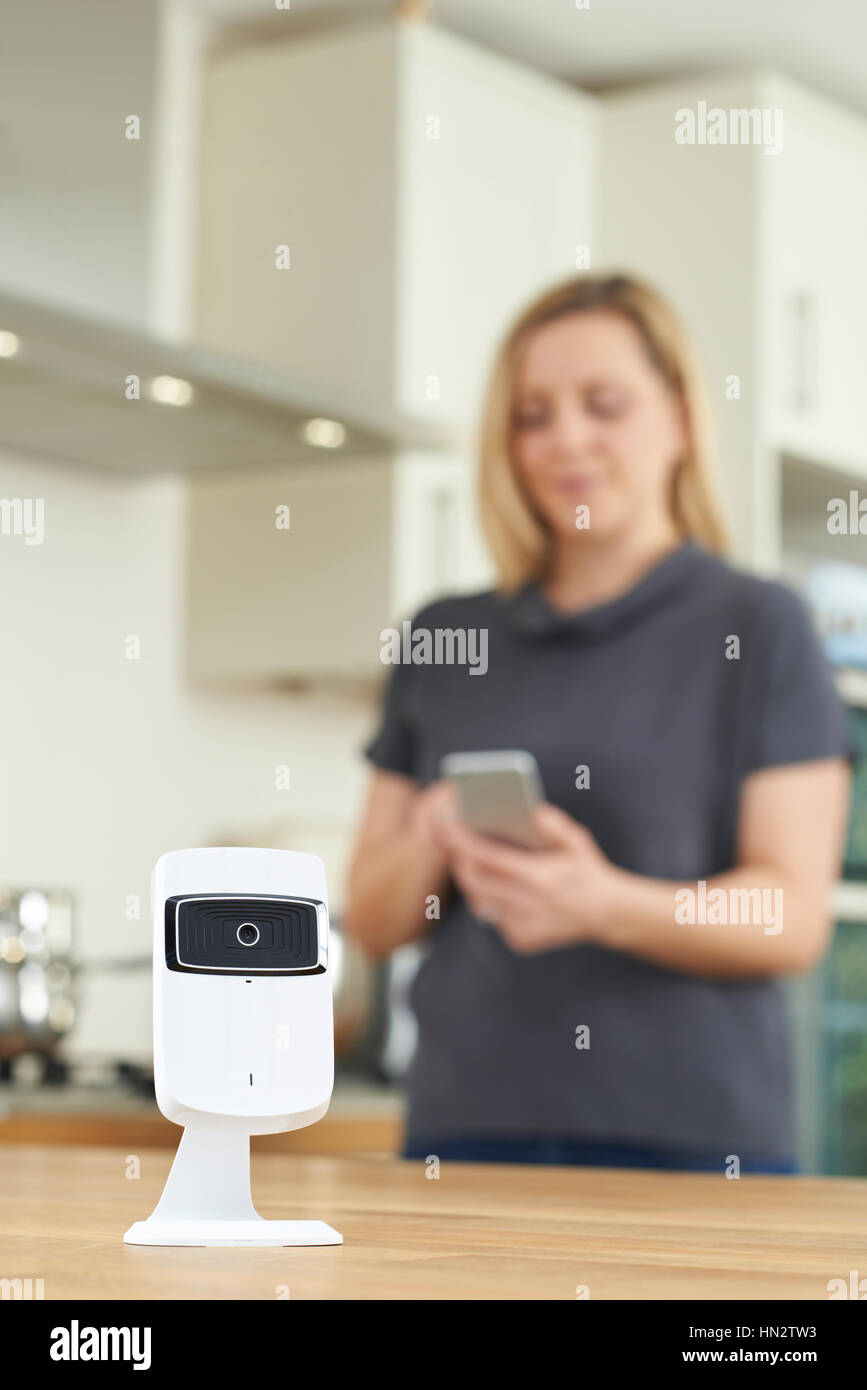 Woman Controlling Smart Security Camera Using App On Mobile Phone Stock ...