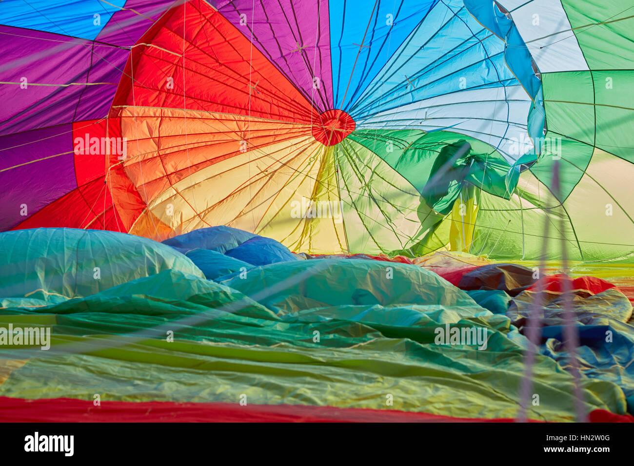 Hot air balloon inflating inside view, man shadow in backlight Stock ...