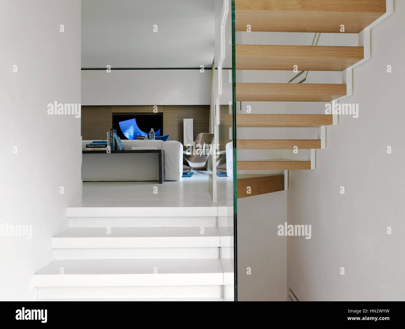 Interior of a luxury house: view of the stairs facing the living room ...