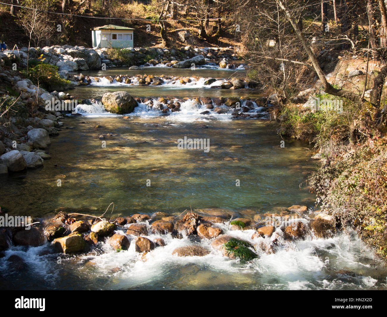 Clear spring mountain stream with trout farm Stock Photo - Alamy