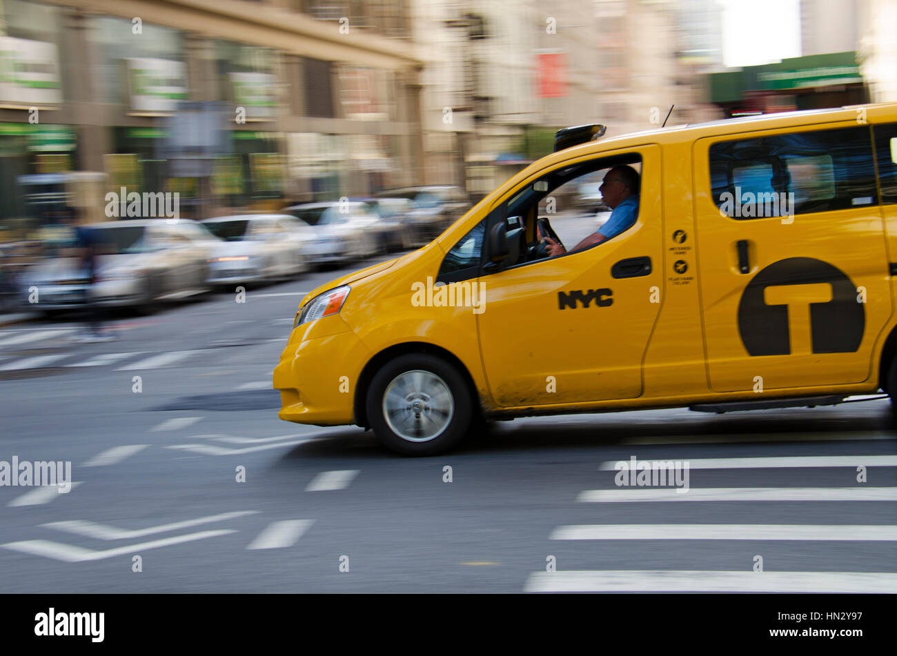 New York City, USA - May 10, 2015: A yellow taxi cab rides the streets ...