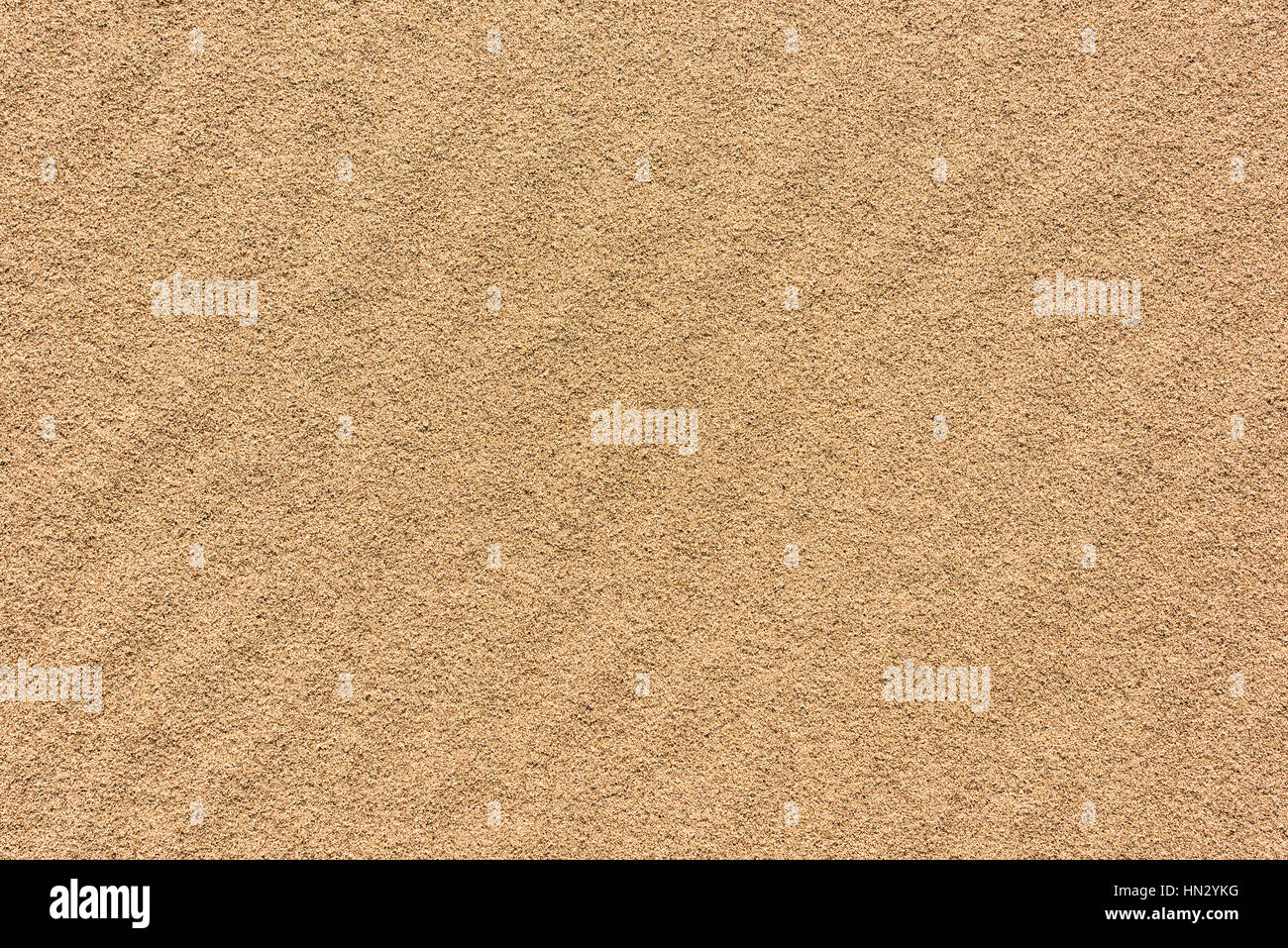 Textured sand of yellow color as background Stock Photo - Alamy