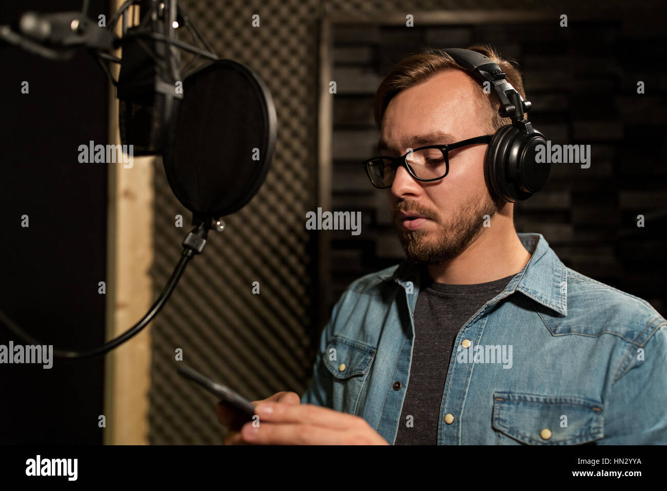 man with headphones at music recording studio Stock Photo - Alamy
