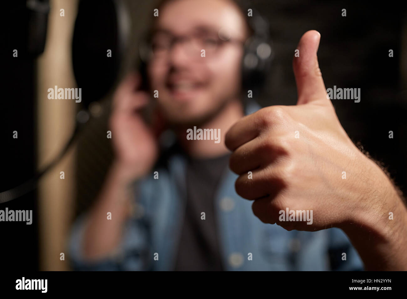 singer showing thumbs up at sound recording studio Stock Photo - Alamy