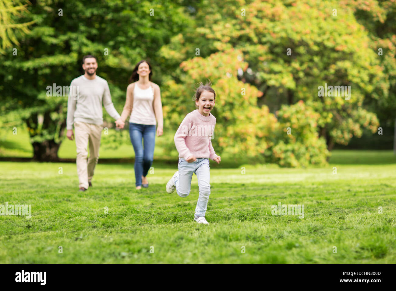 happy family walking in summer park and having fun Stock Photo - Alamy