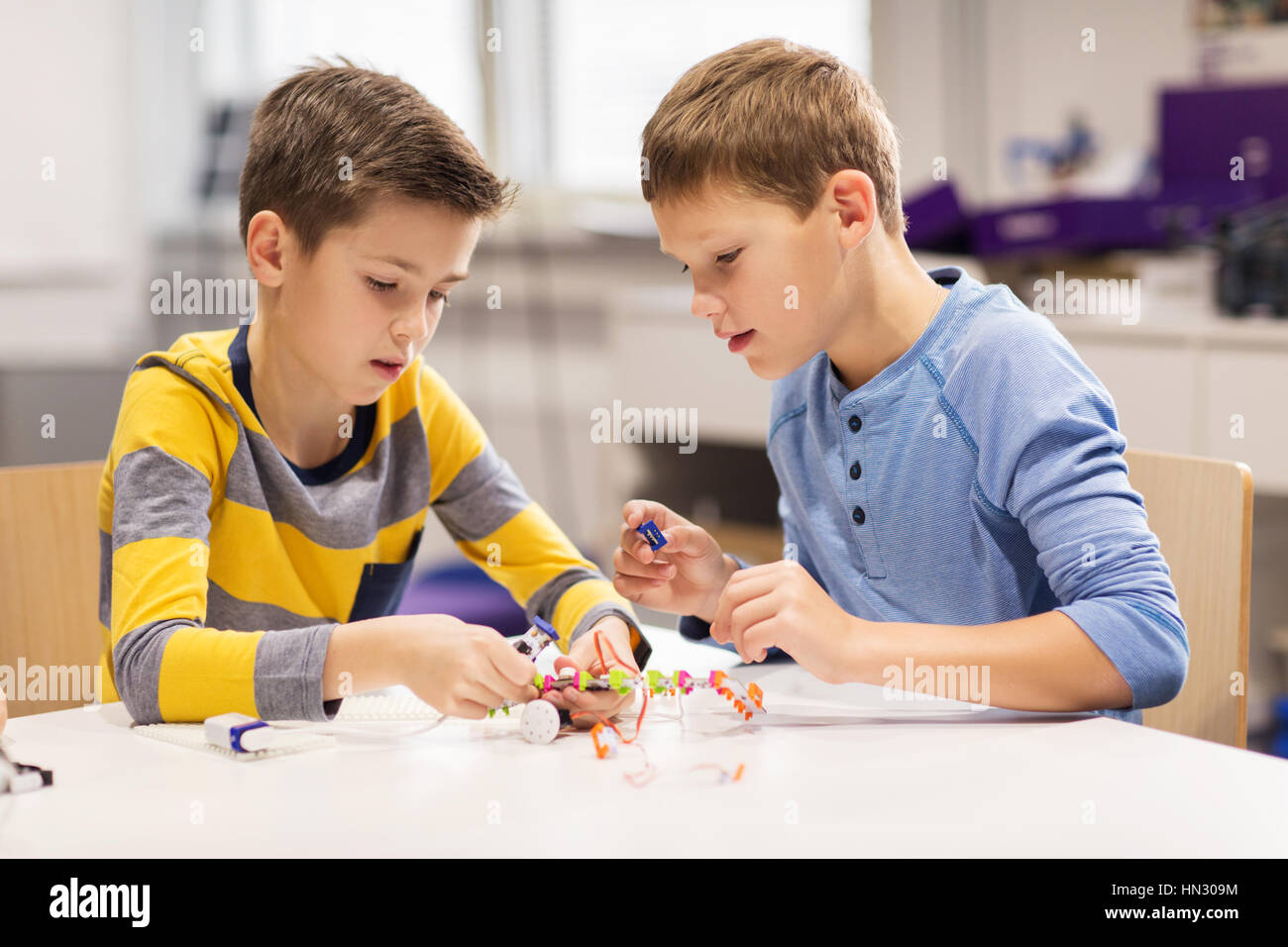 happy children building robots at robotics school Stock Photo - Alamy