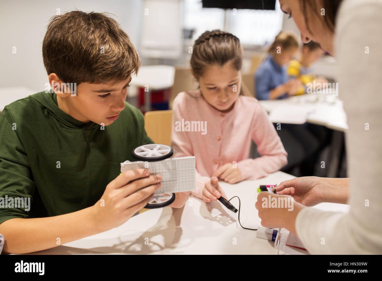 happy children building robots at robotics school Stock Photo - Alamy