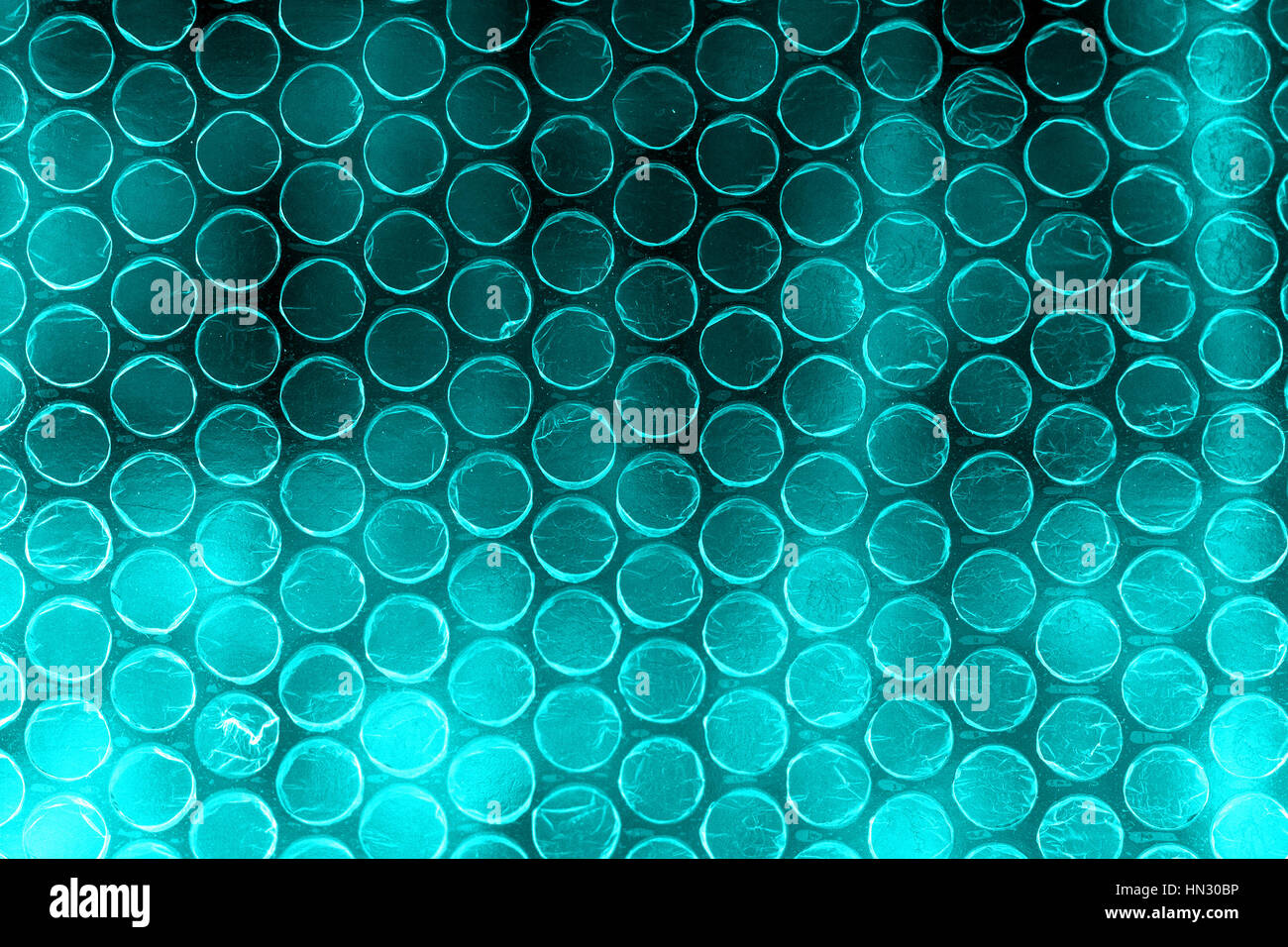 Plastic polymer bubble wrap in high contrast vivid cyan blue color ...