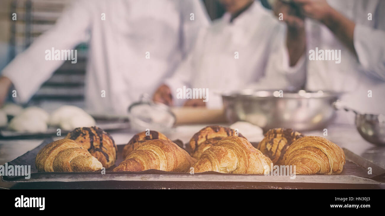 Team of bakers working at counter in the kitchen of the bakery Stock ...