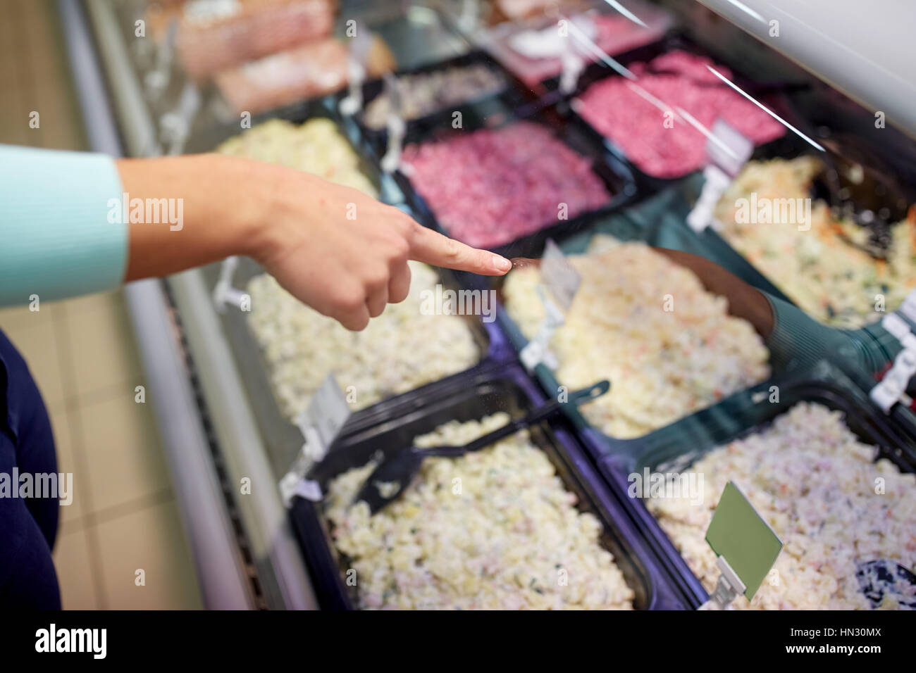 customer hand pointing at salads on grocery stall Stock Photo - Alamy