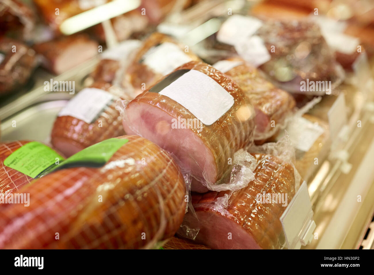 ham at grocery store stall Stock Photo - Alamy