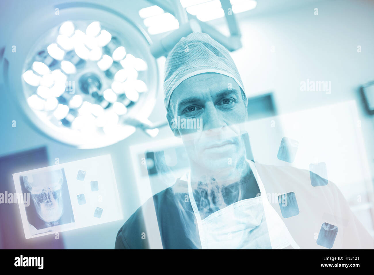 Overhead of a x-ray of a human skull against portrait of surgeon in ...