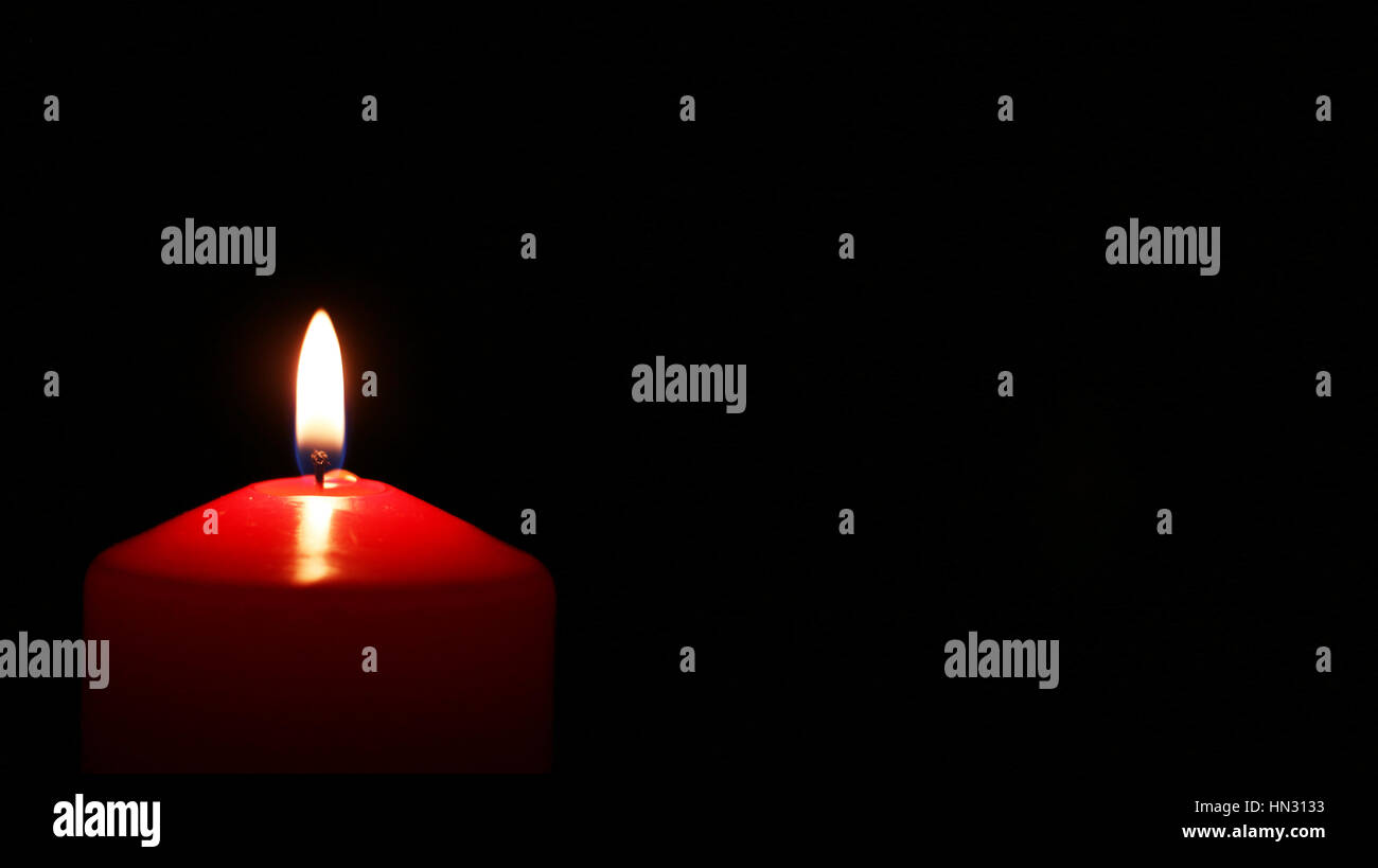 red candle lit left Stock Photo - Alamy