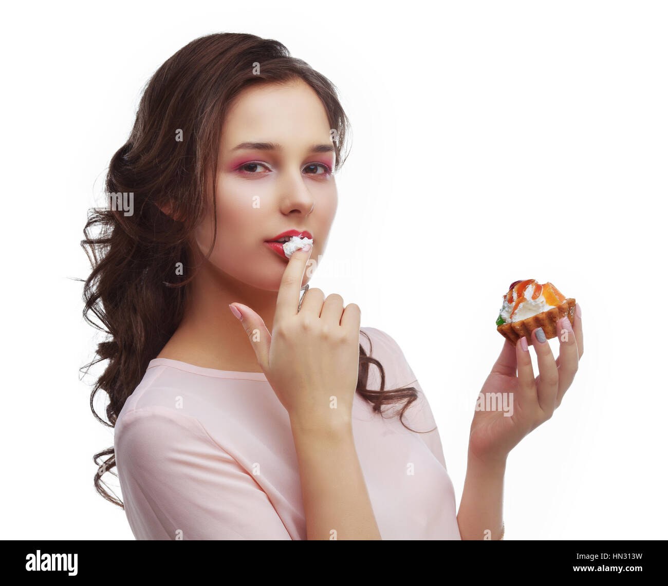 beautiful young woman eating dessert, studio background Stock Photo - Alamy