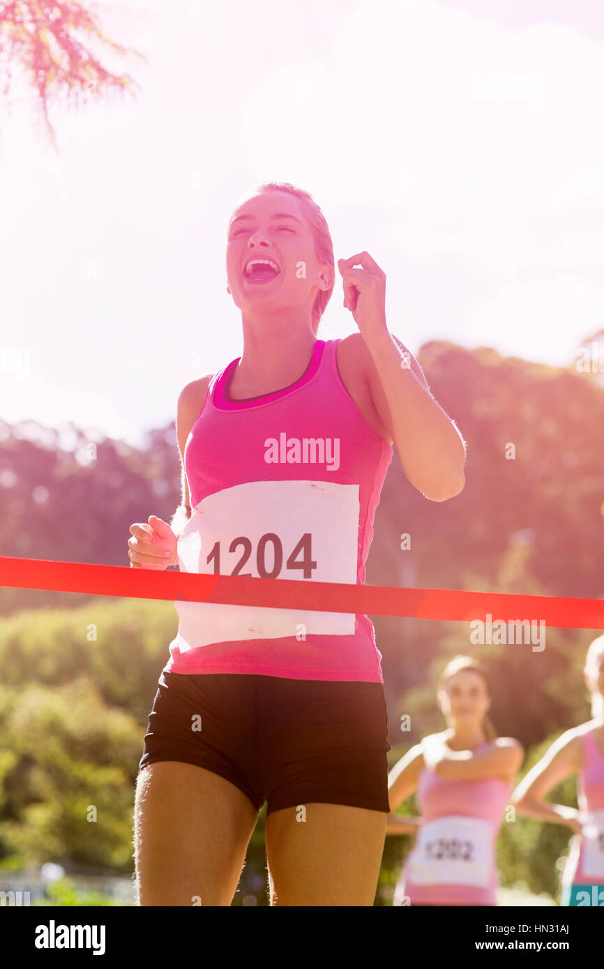 Female athlete crossing finish line hi-res stock photography and images ...