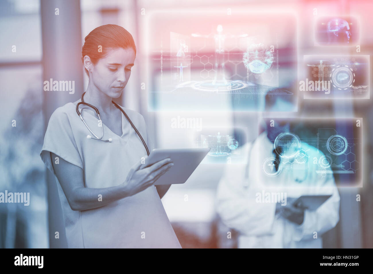 Medical interface in blue and black against doctor and nurse using ...