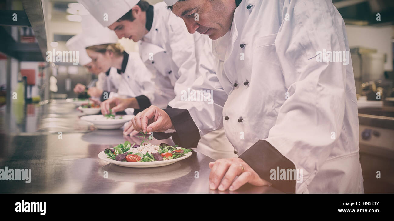 Chefs preparing their salads in the kitchen Stock Photo - Alamy