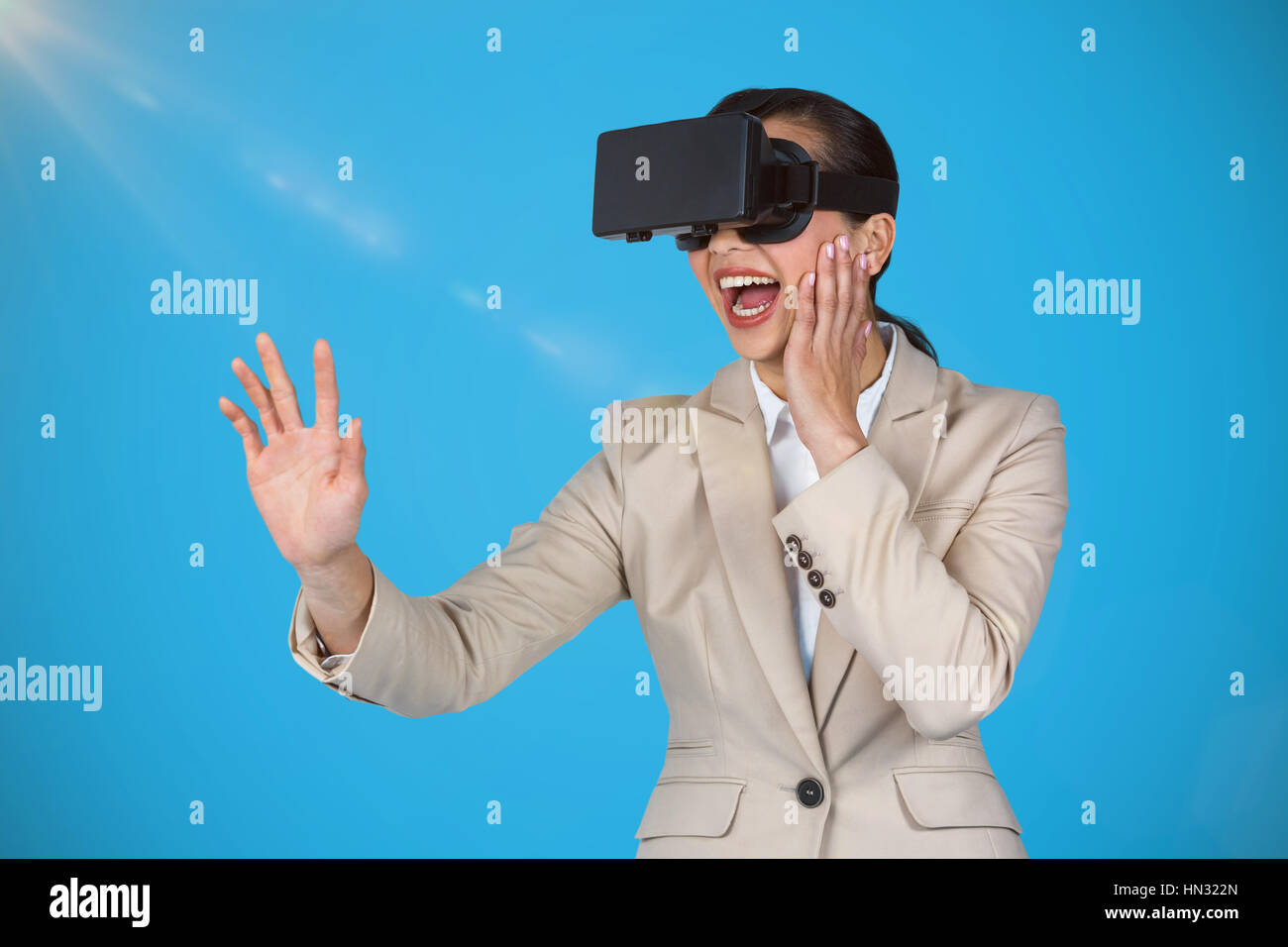 Excited businesswoman wearing virtual video glasses against blue ...