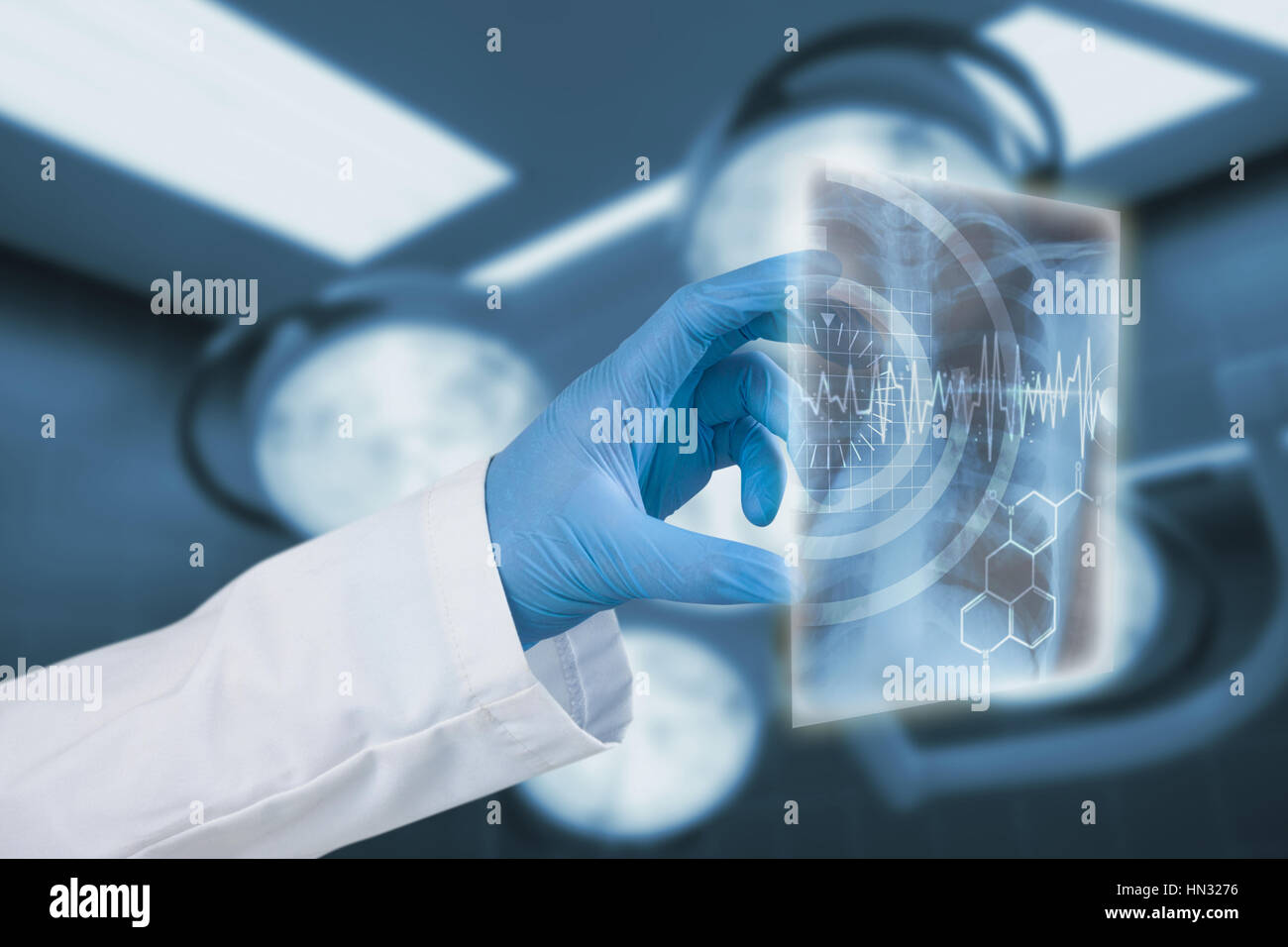 Hand of female scientist conducting experiment against surgical light ...