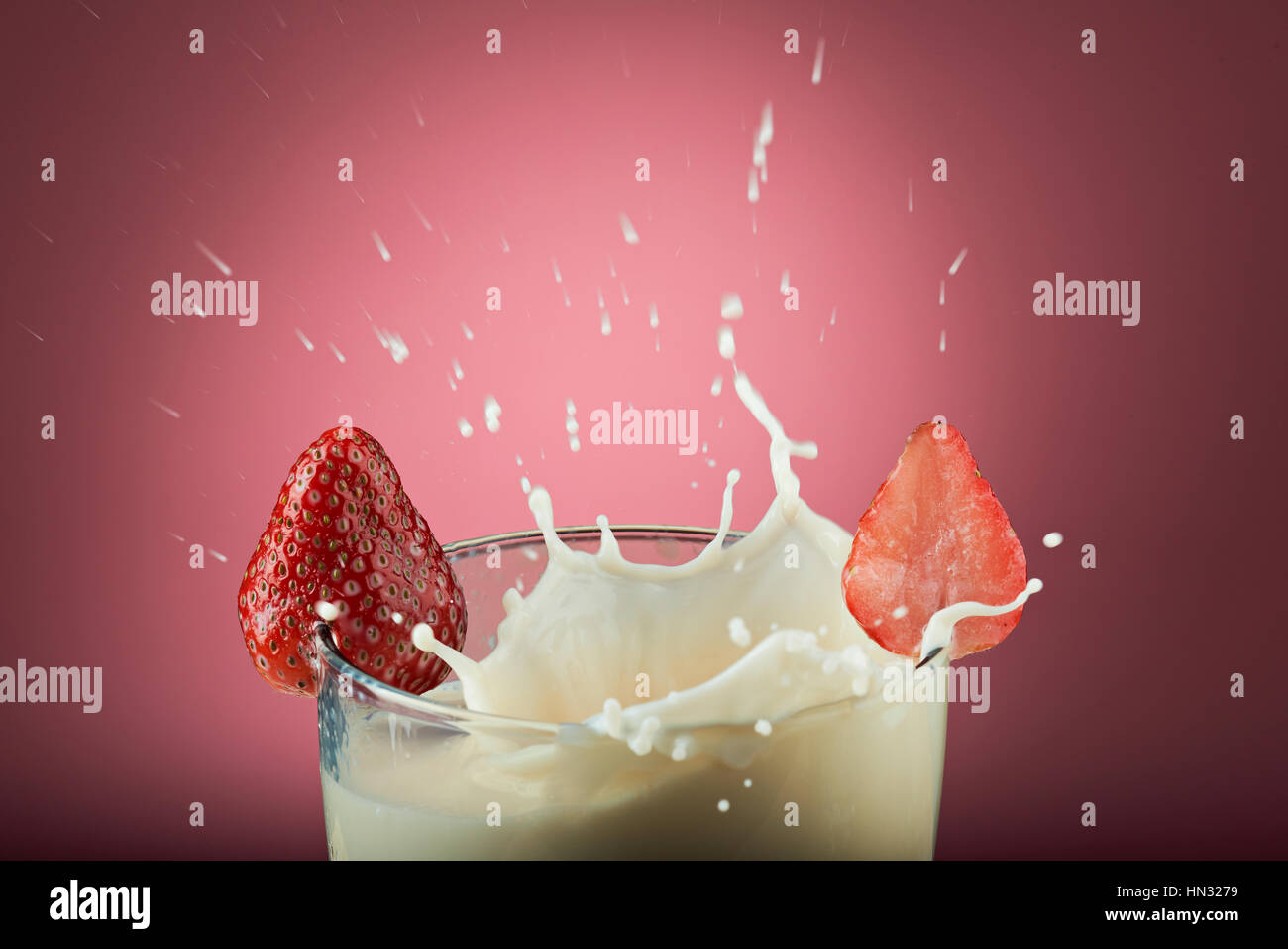 Flying milk drops splashes in milkshake isolated on pink Stock Photo ...