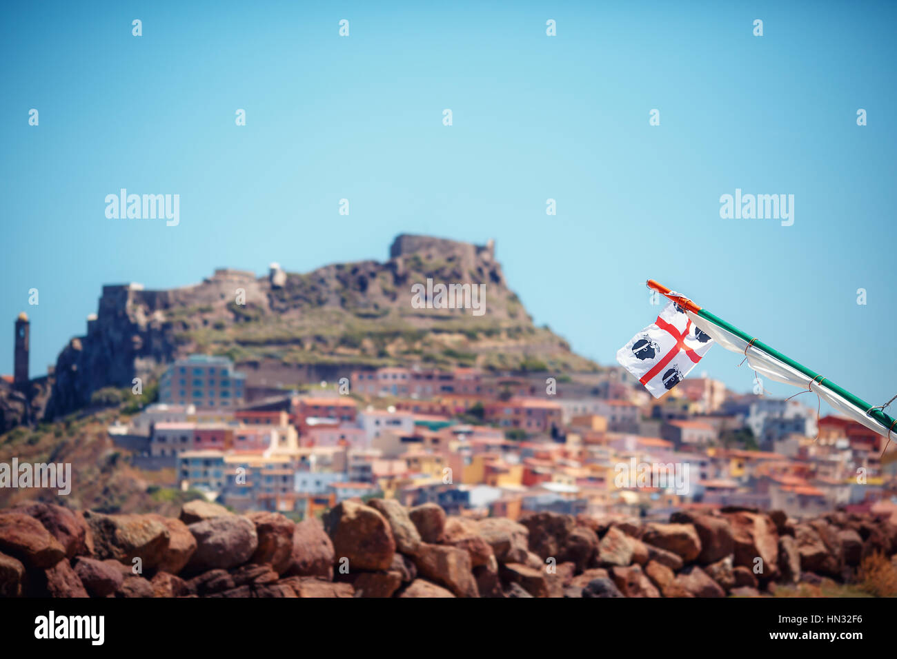 Traditional Four Moors flag of Sardinia's Region against Medieval town ...