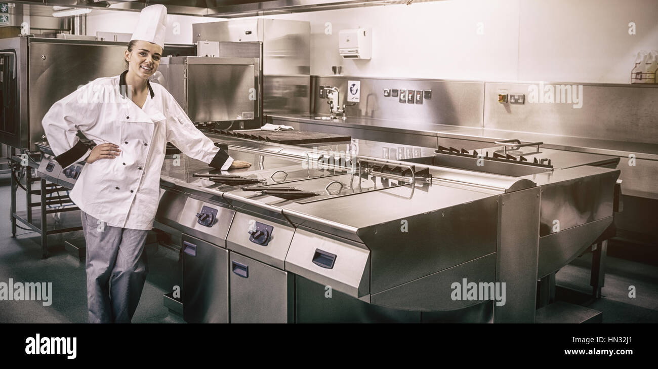 Young chef standing next to work surface in professional kitchen Stock ...