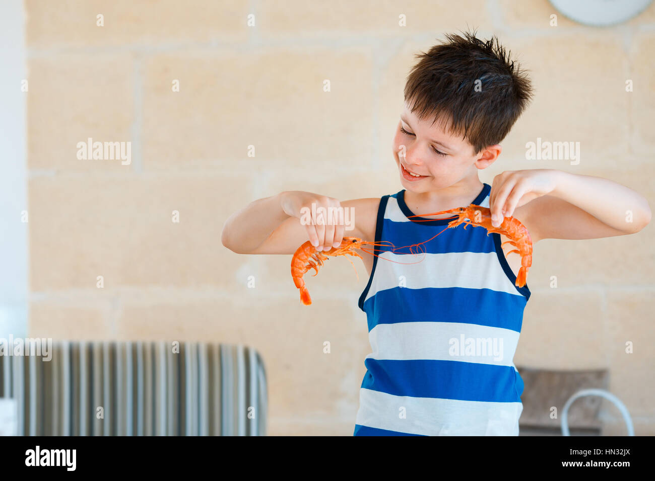 Cute little boy holding big prawn in hands for today's meal Stock Photo ...