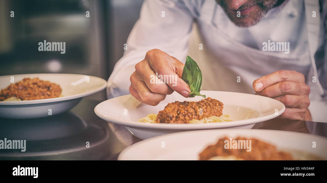 Closeup mid section of a male chef preparing pizza in kitchen Stock ...