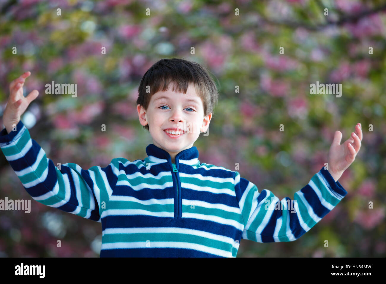 Cute little boy playing in spring garden Stock Photo - Alamy