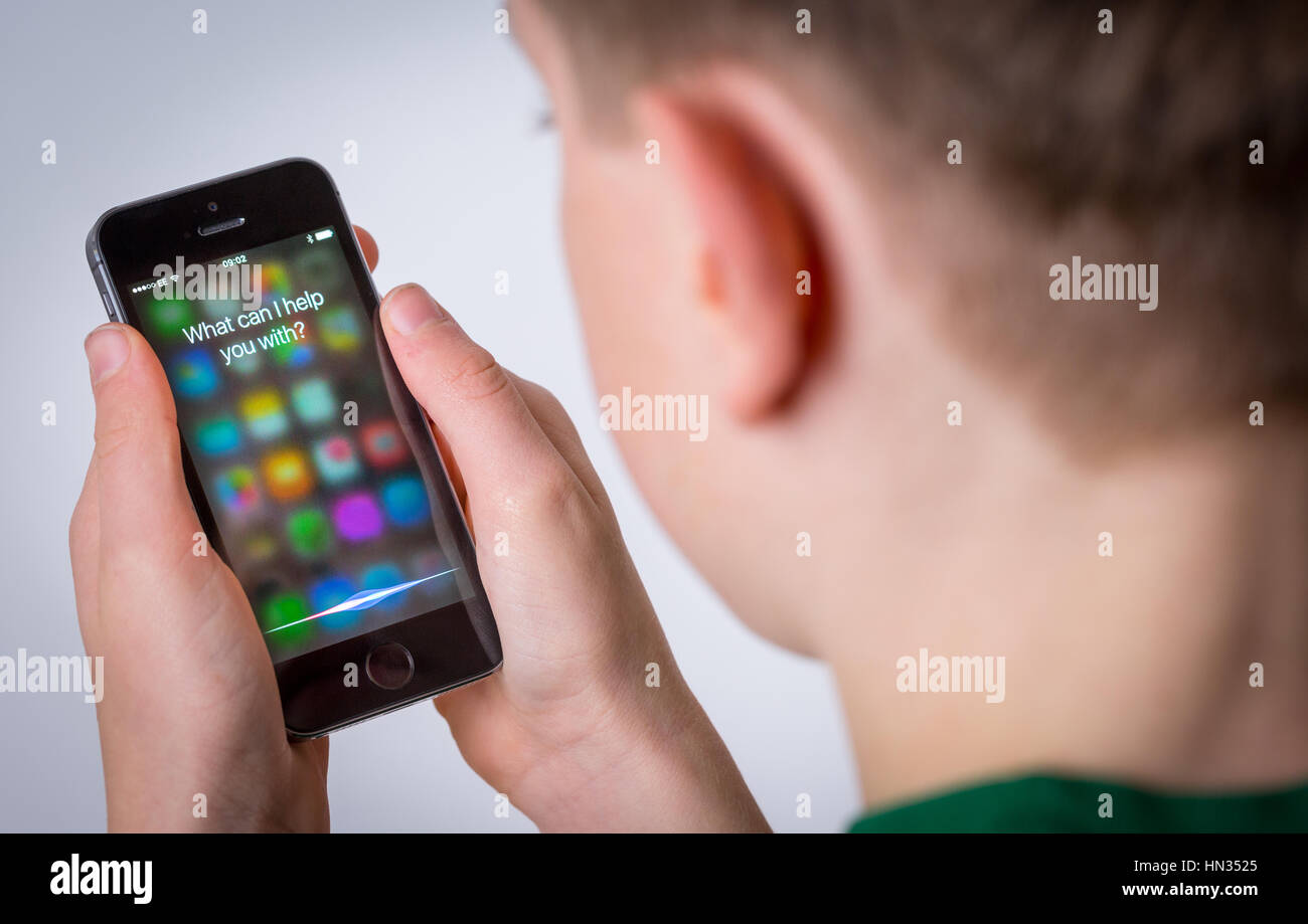 A teenage boy using Siri on an iPhone Stock Photo - Alamy