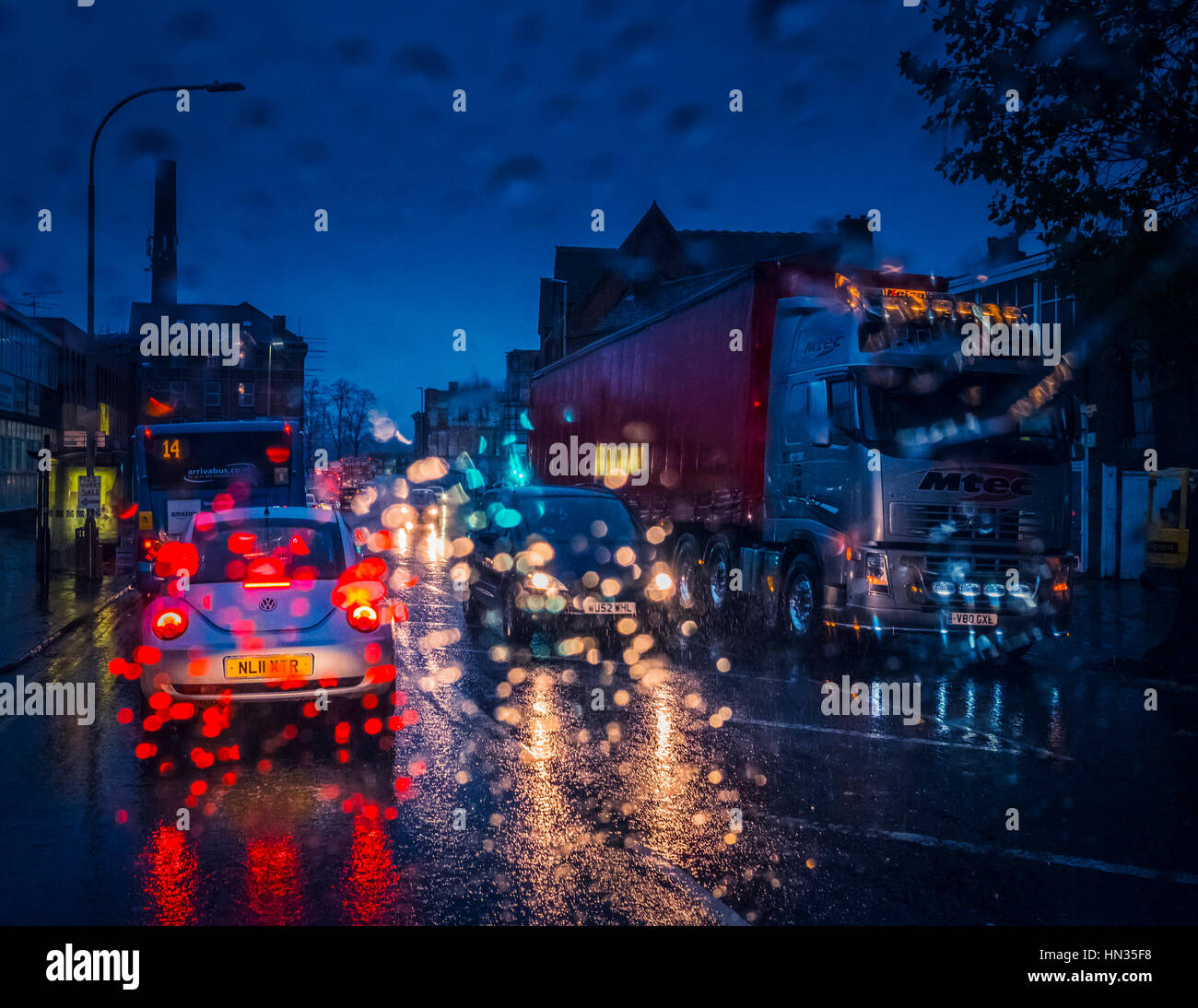 Driving through traffic on a rainy night Stock Photo - Alamy