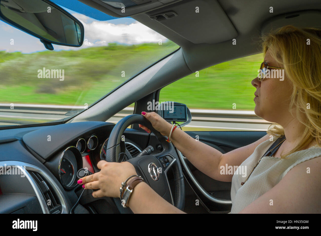 Young woman driving fast along a motorway Stock Photo - Alamy