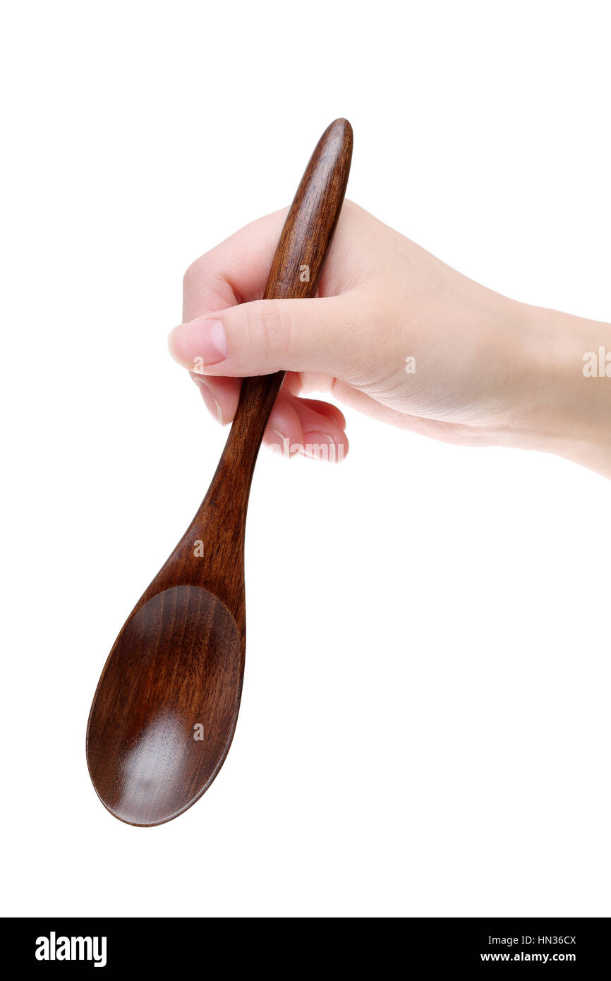 Hand holding wooden spoon isolated on white background Stock Photo - Alamy