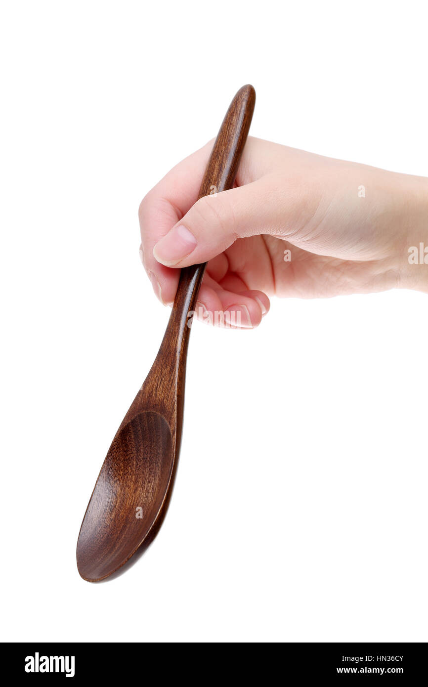 Hand holding wooden spoon isolated on white background Stock Photo - Alamy