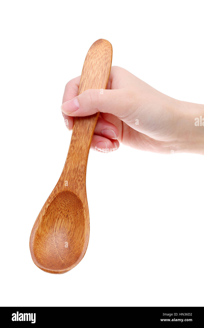 Hand holding wooden spoon isolated on white background Stock Photo - Alamy