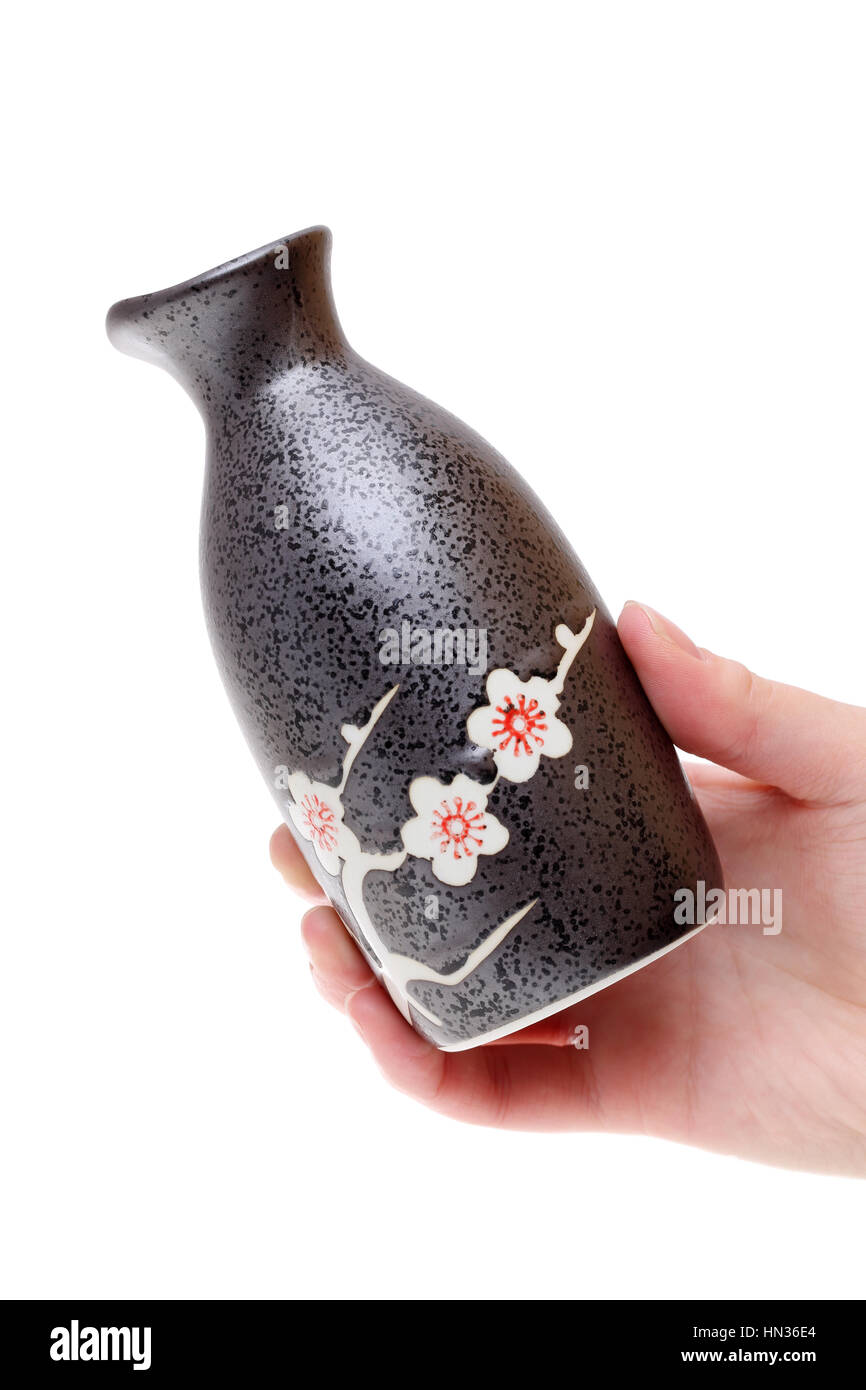 Hand holding traditional sake bottle isolated on white background Stock ...